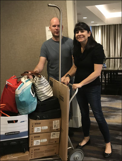 Mickey is putting some bags into a cart filled with boxes that Eileen ...