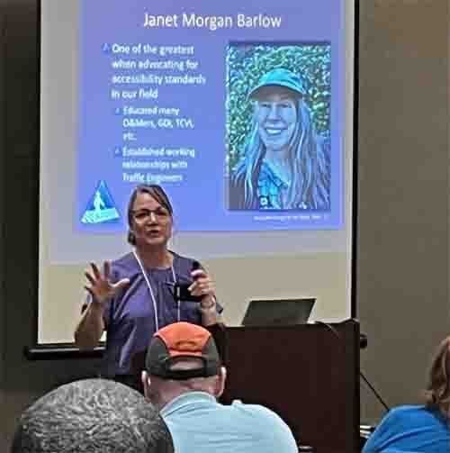 Picture shows Jen presenting, on the screen we see a picture of Janet ...