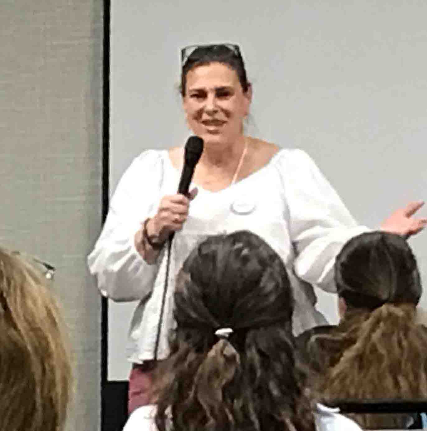 picture shows Erika speaking to the audience.